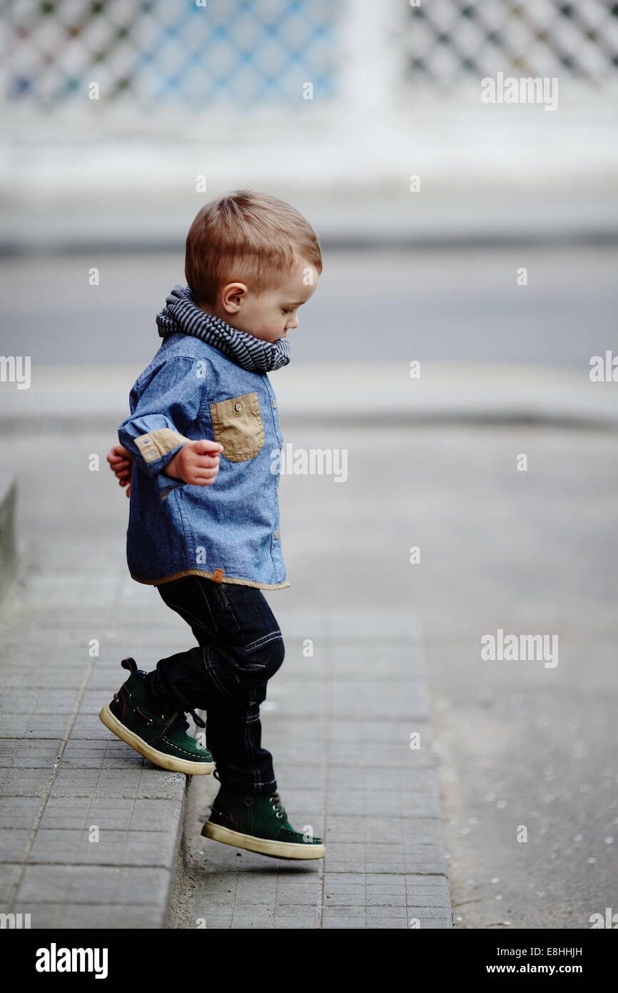 little boy walks alone on stairway Stock Photo - Alamy