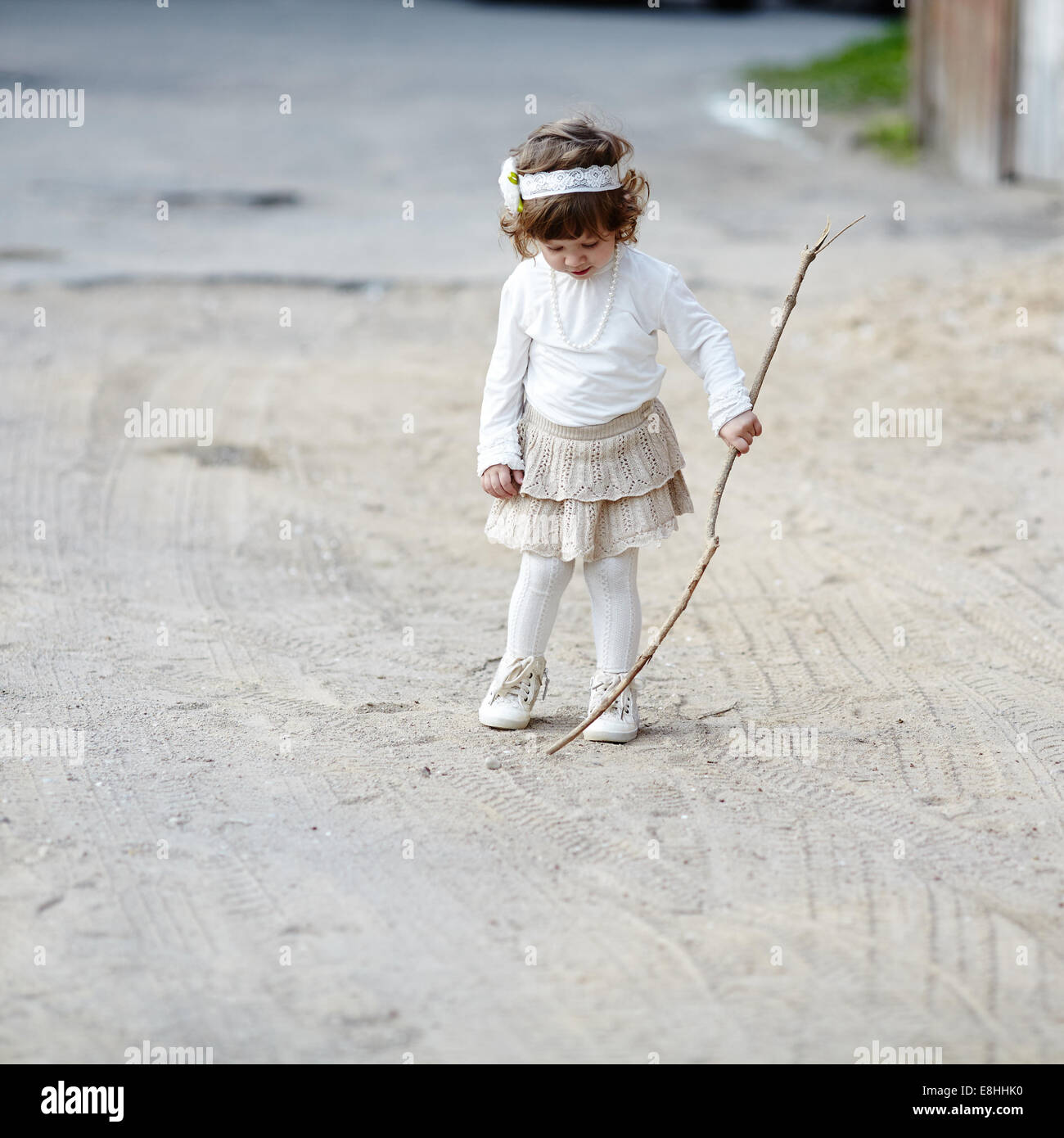 cute little girl plays with stick Stock Photo - Alamy