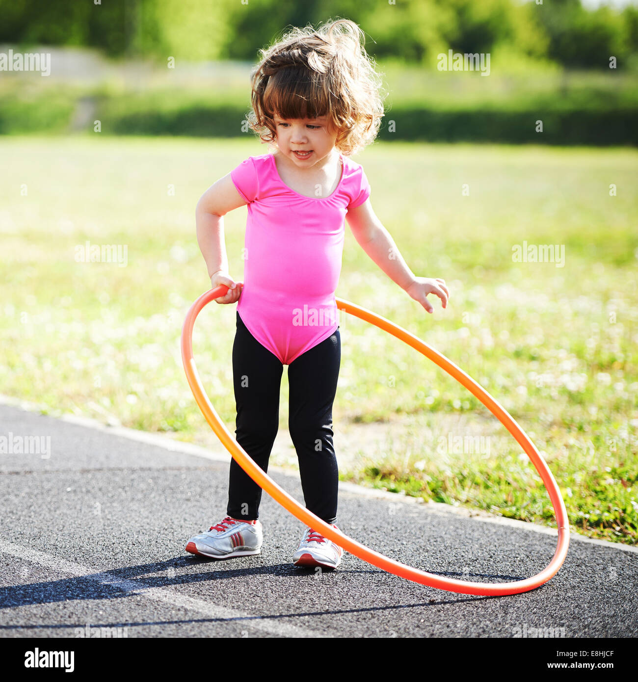 little girl learns to spin the Hoop Stock Photo - Alamy