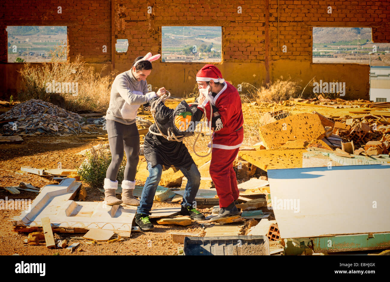 Santa and the Easter Bunny kidnapping the Halloween monster Stock Photo ...