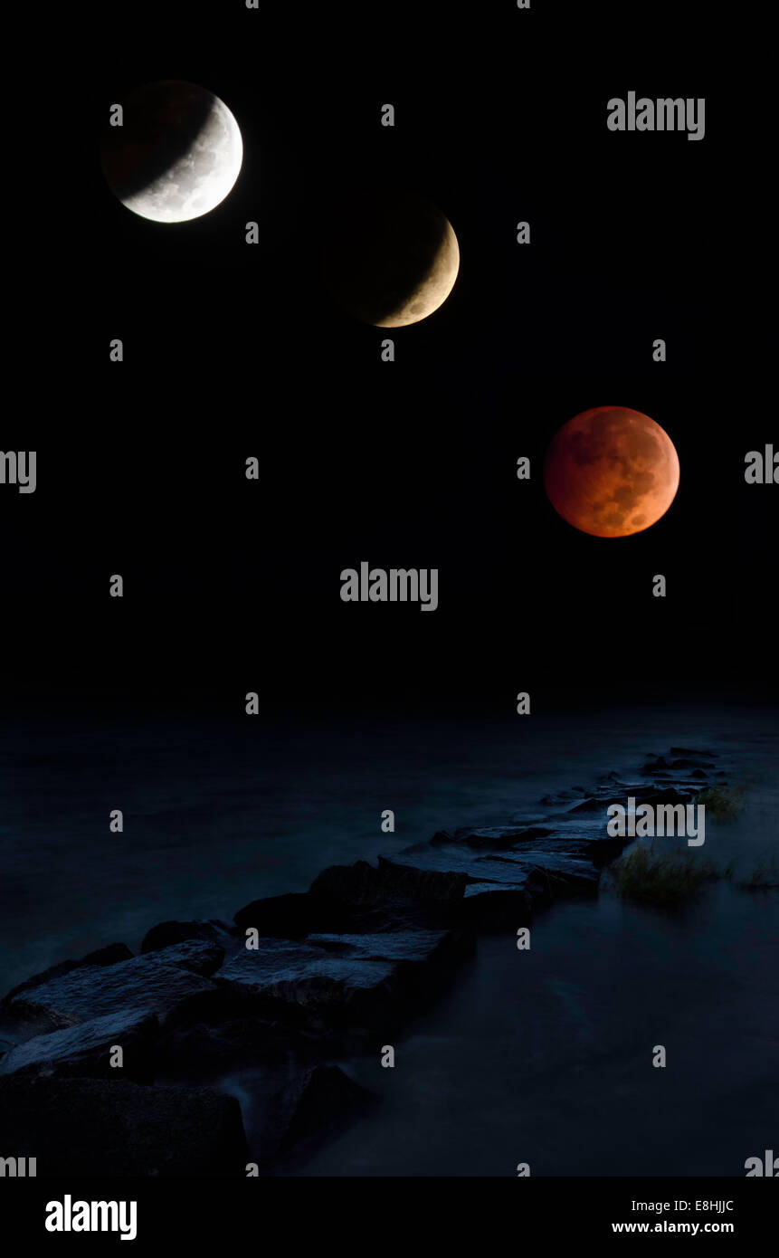 Lunar Eclipse Series over Ocean sea wall Stock Photo - Alamy