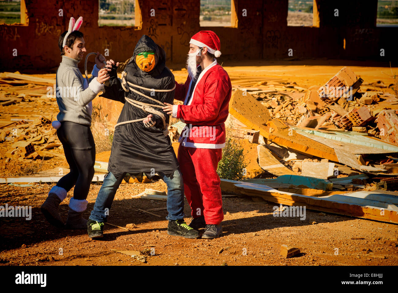 Santa and the Easter Bunny kidnapping the Halloween monster Stock Photo ...