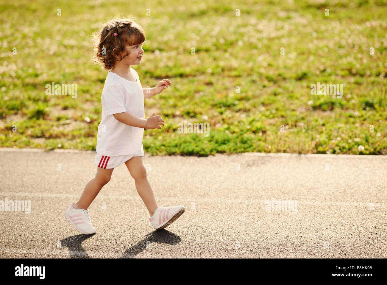 cute girl running at stadium photo Stock Photo - Alamy