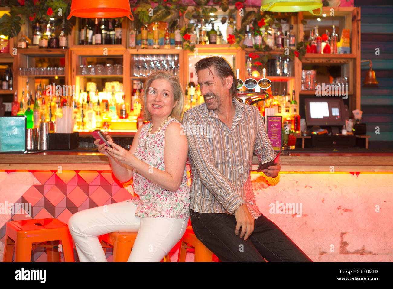 Middle aged couple using dating apps on their smartphones to meet Stock ...