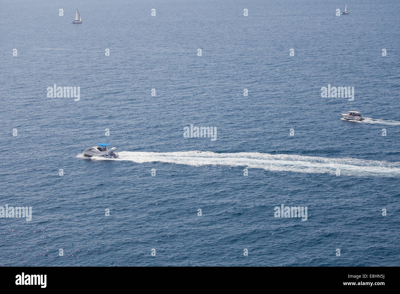 speeding motor boats dash across, the seas, surface leaving in their ...