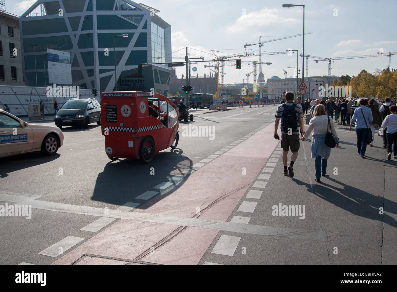 Street Cars Velotaxi cycle rickshaw People walking Berlin Germany Stock ...