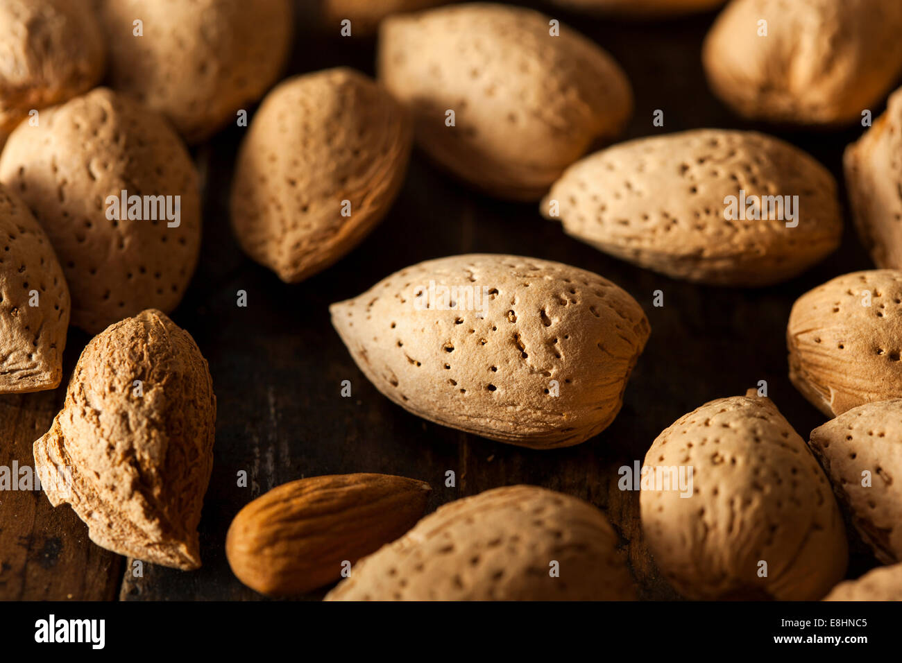 Raw Unshelled Organic Almonds on a Background Stock Photo - Alamy