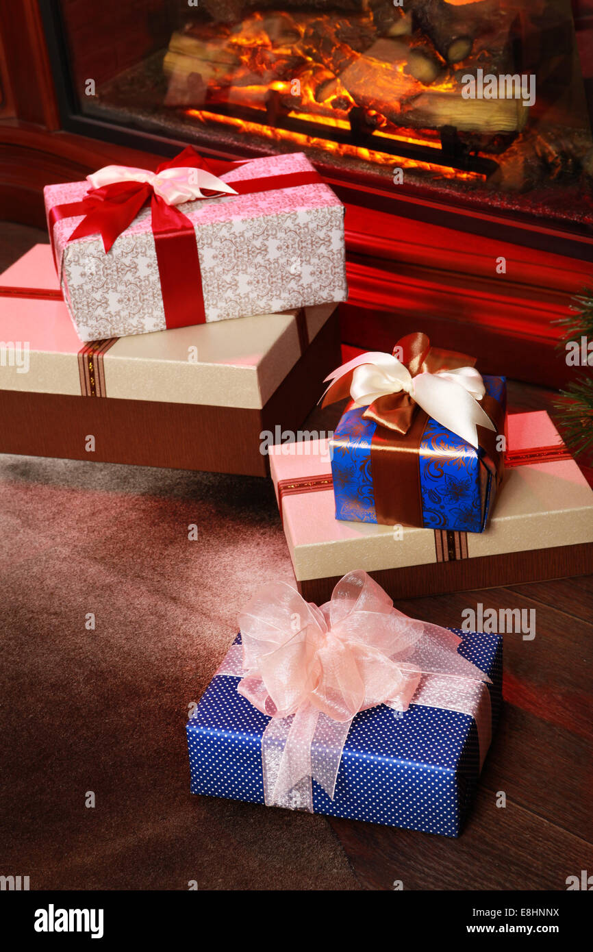 Christmas gift boxes in the interior with a fireplace Stock Photo - Alamy
