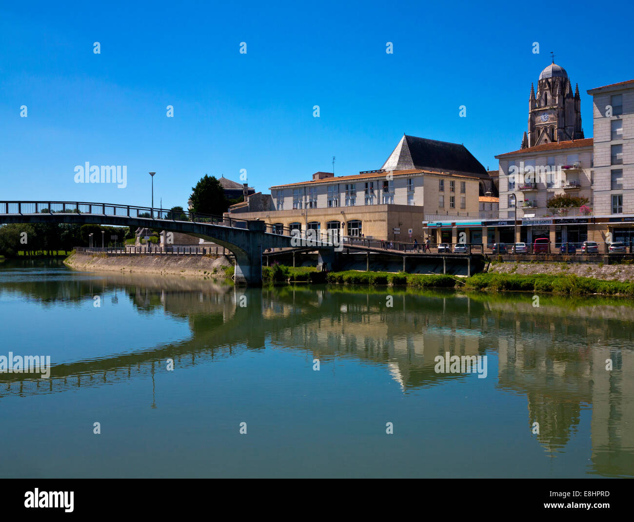 Cathedral tower and buildings reflected in River Charente at Saintes a ...