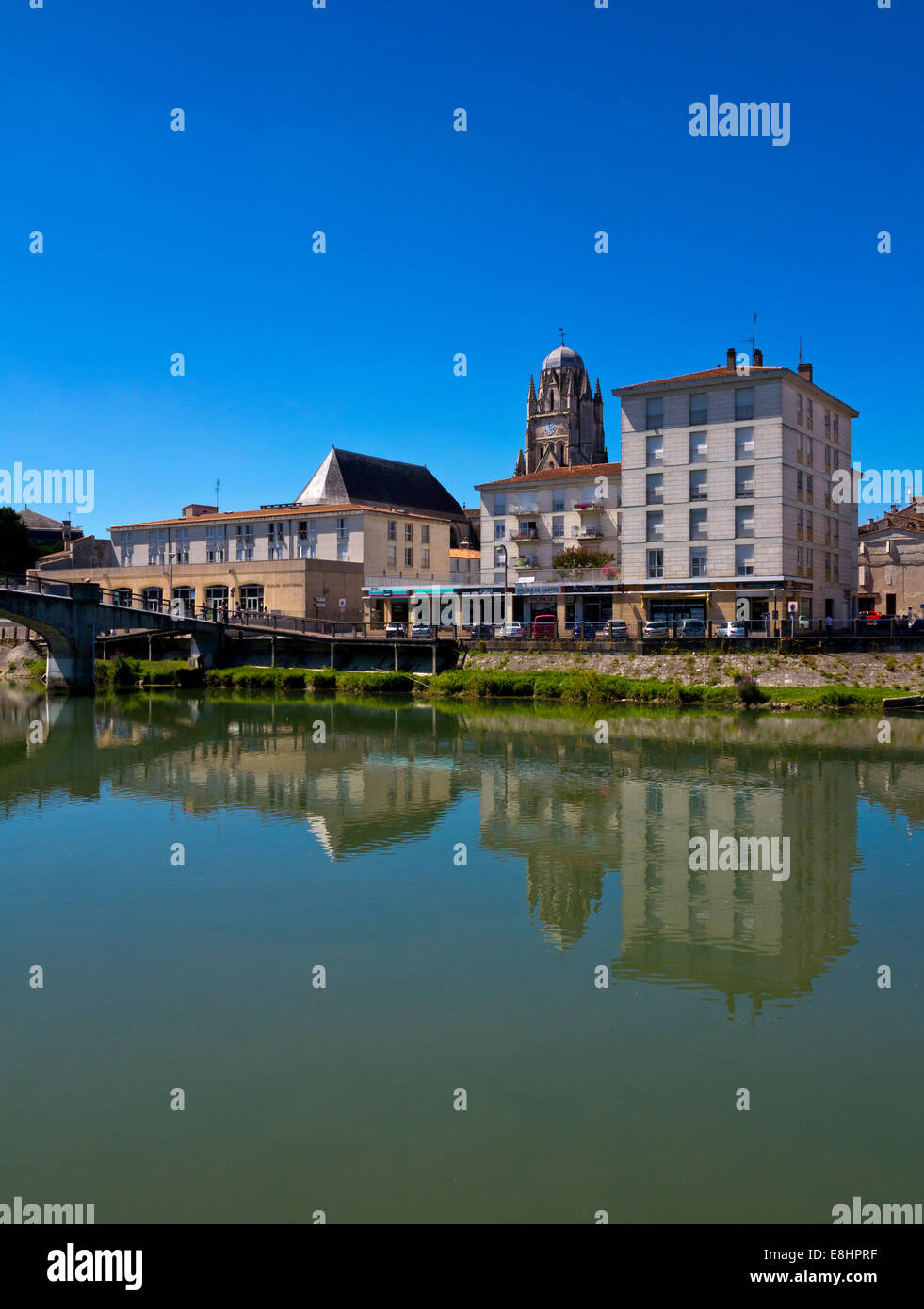 Cathedral tower and buildings reflected in River Charente at Saintes a ...