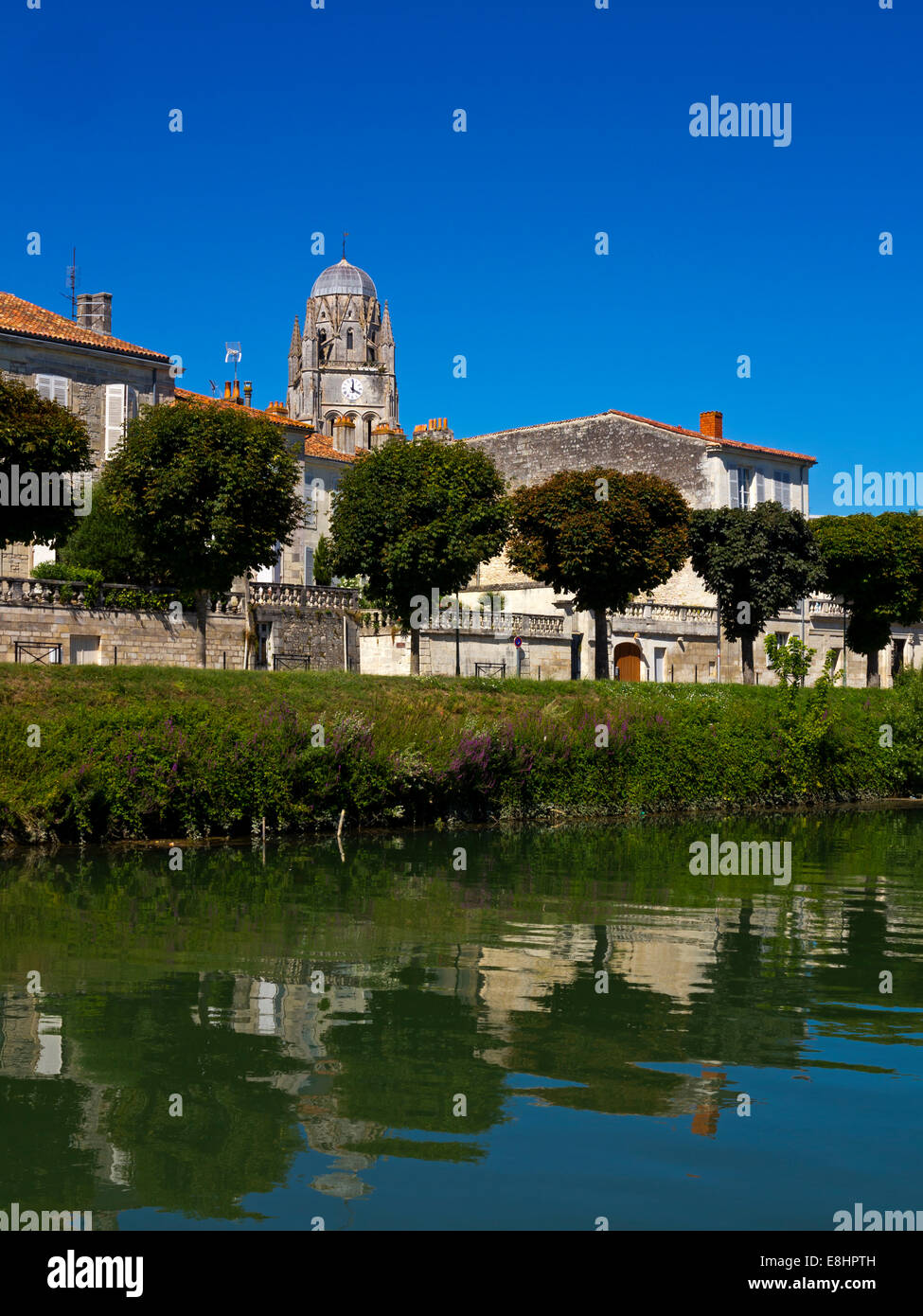 Cathedral tower and buildings reflected in River Charente at Saintes a ...
