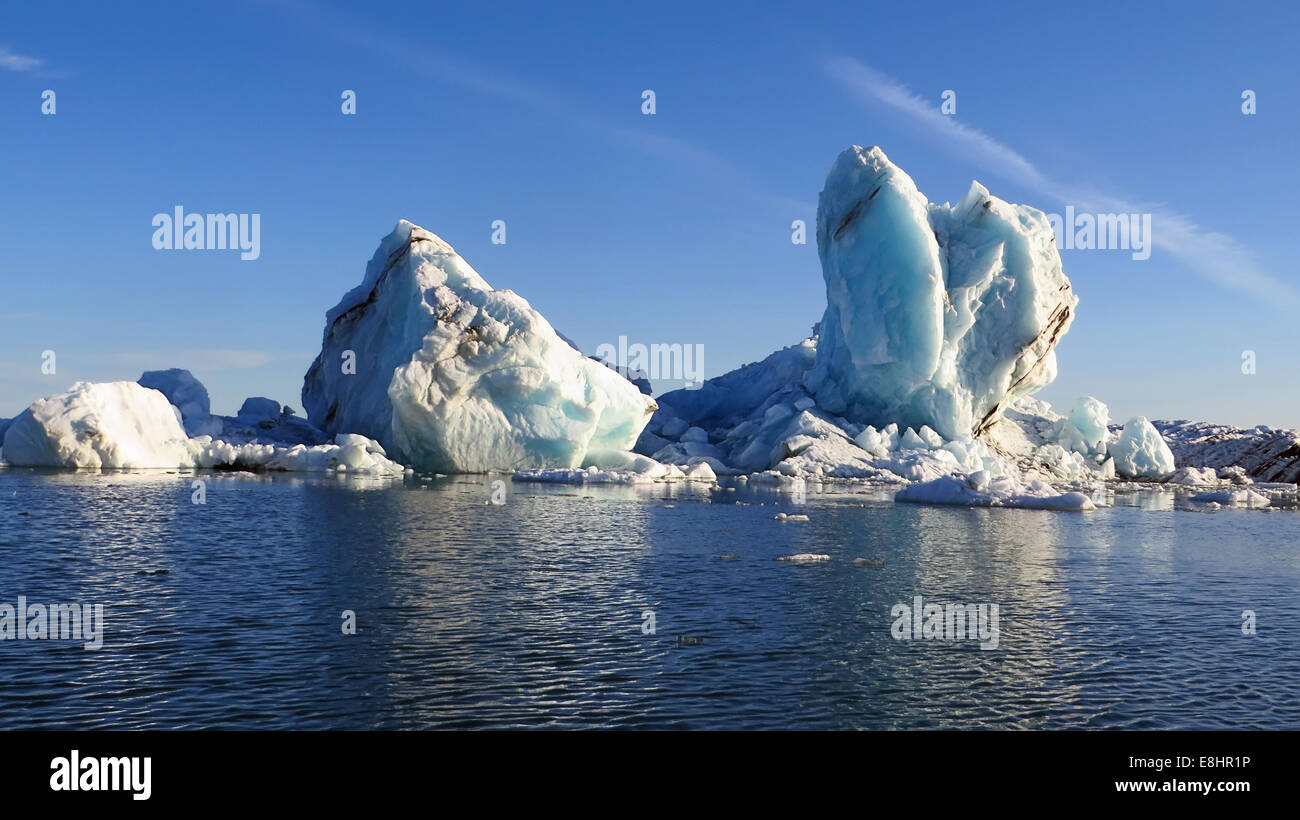 iceberg floating close to a glacier in Iceland Stock Photo - Alamy