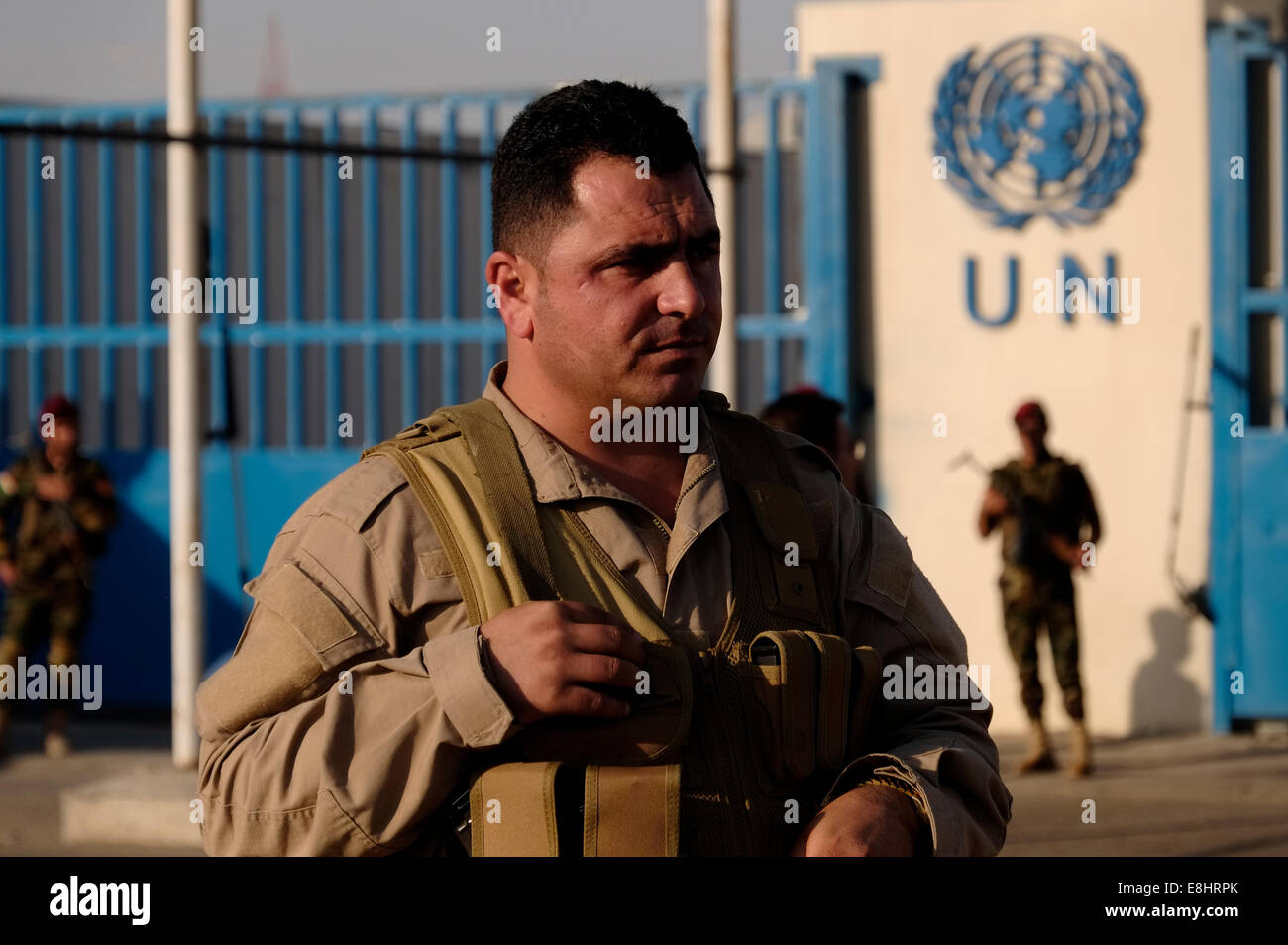 Kurdish Peshmerga soldiers stand guard in front of UN headquarters as ...