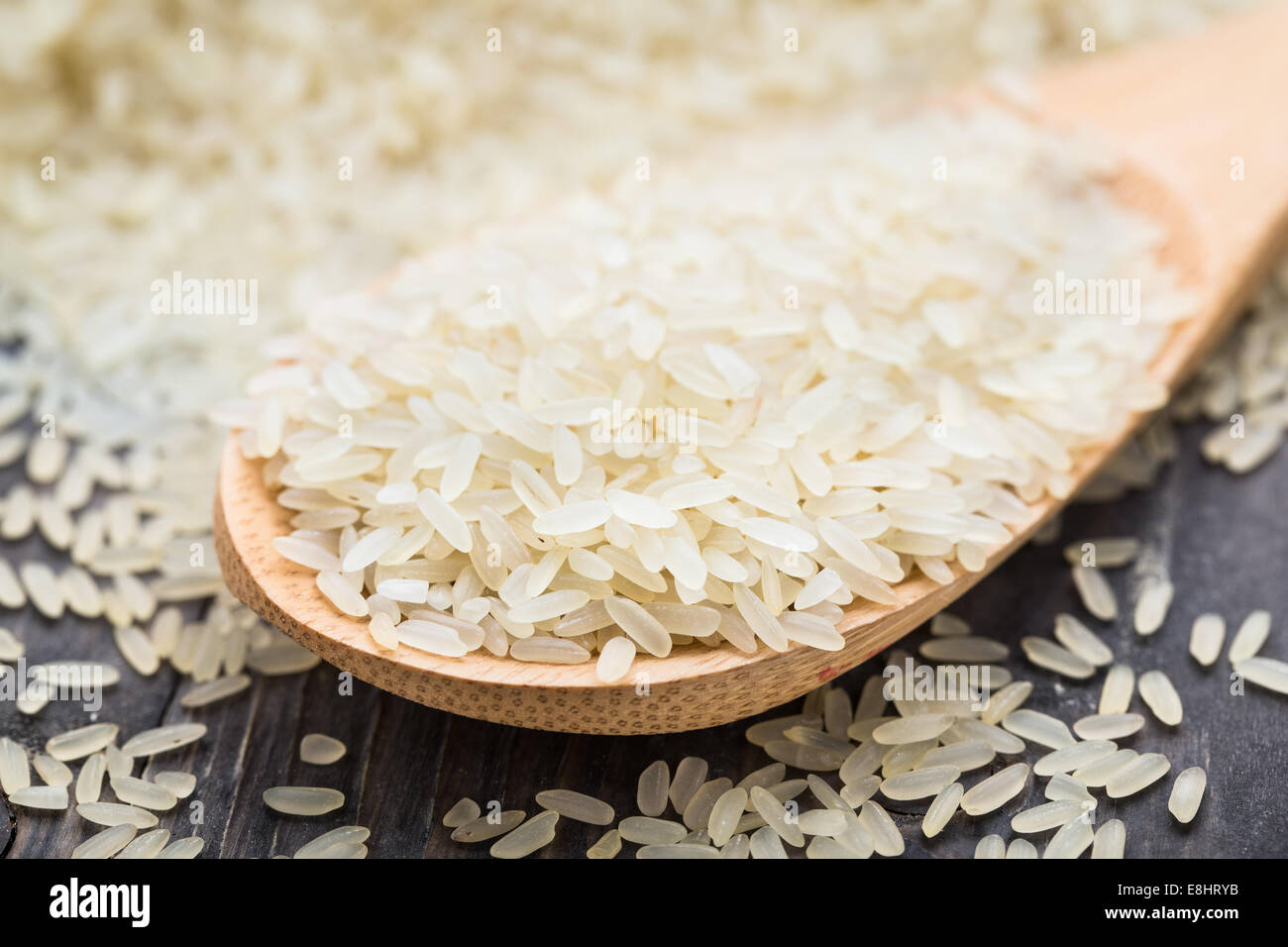 White uncooked rice in a spoon Stock Photo - Alamy