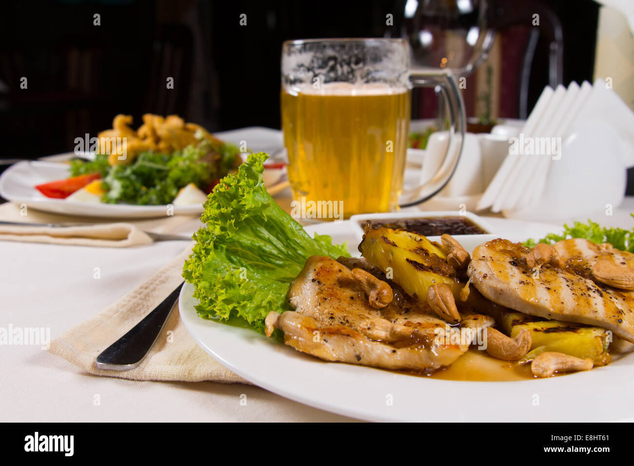 Close up Appetizing Main Dishes and Mug of Beer on White Dining Table ...