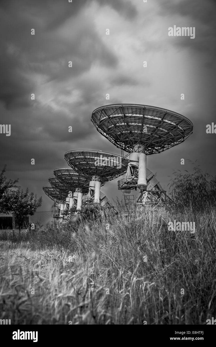 Stormy clouds in the sky, Radio telescope satellite dish array in a ...