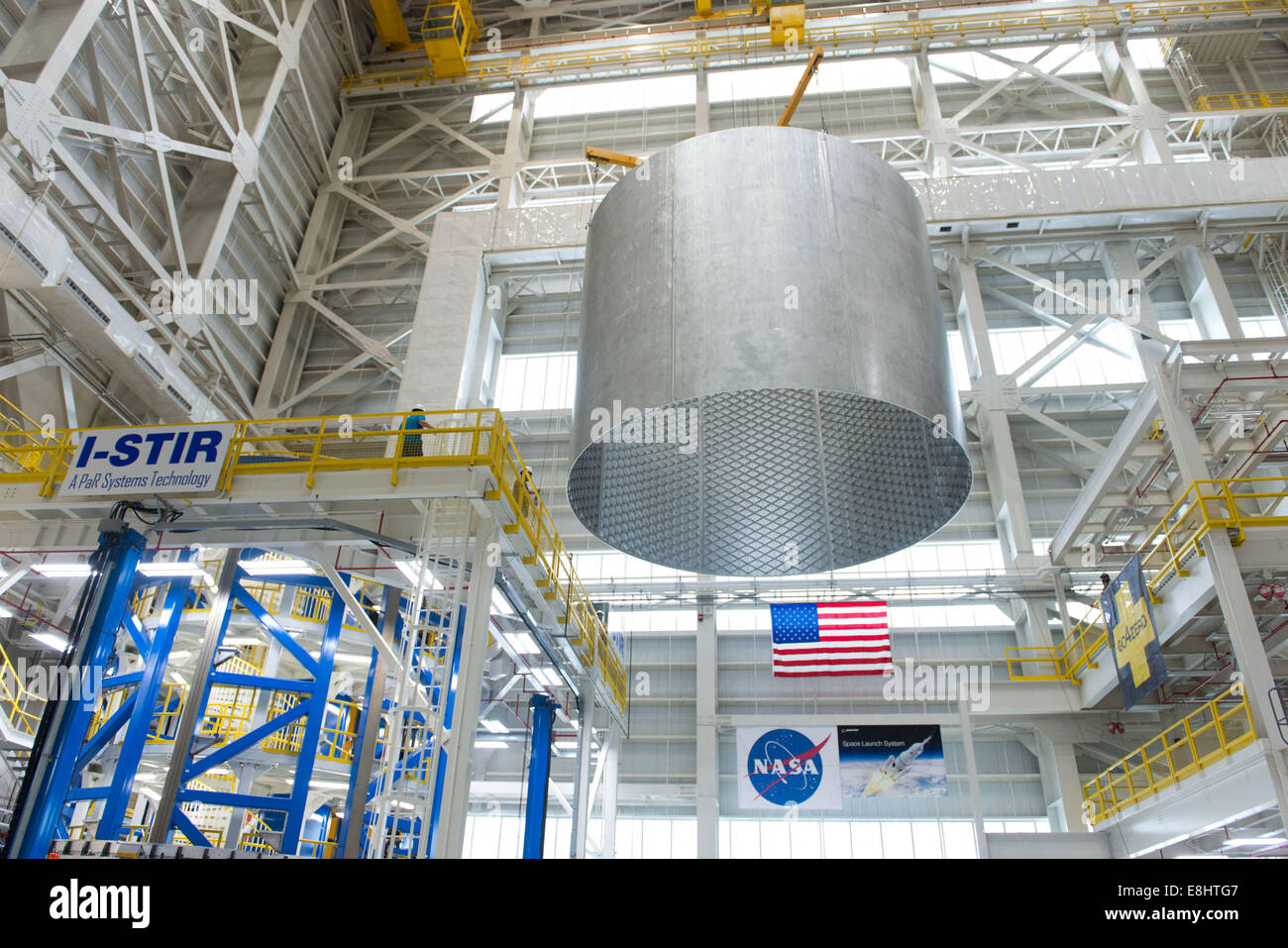 Engineers at NASA's Michoud Assembly Facility transfer a 22-foot-tall ...