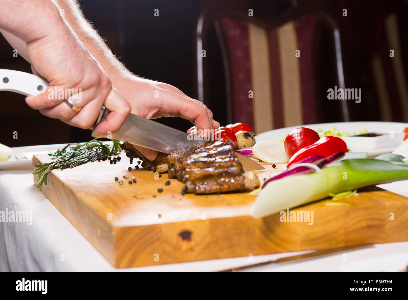 Close Up of Hand Chopping Meat with Knife on Cutting Board Amongst ...