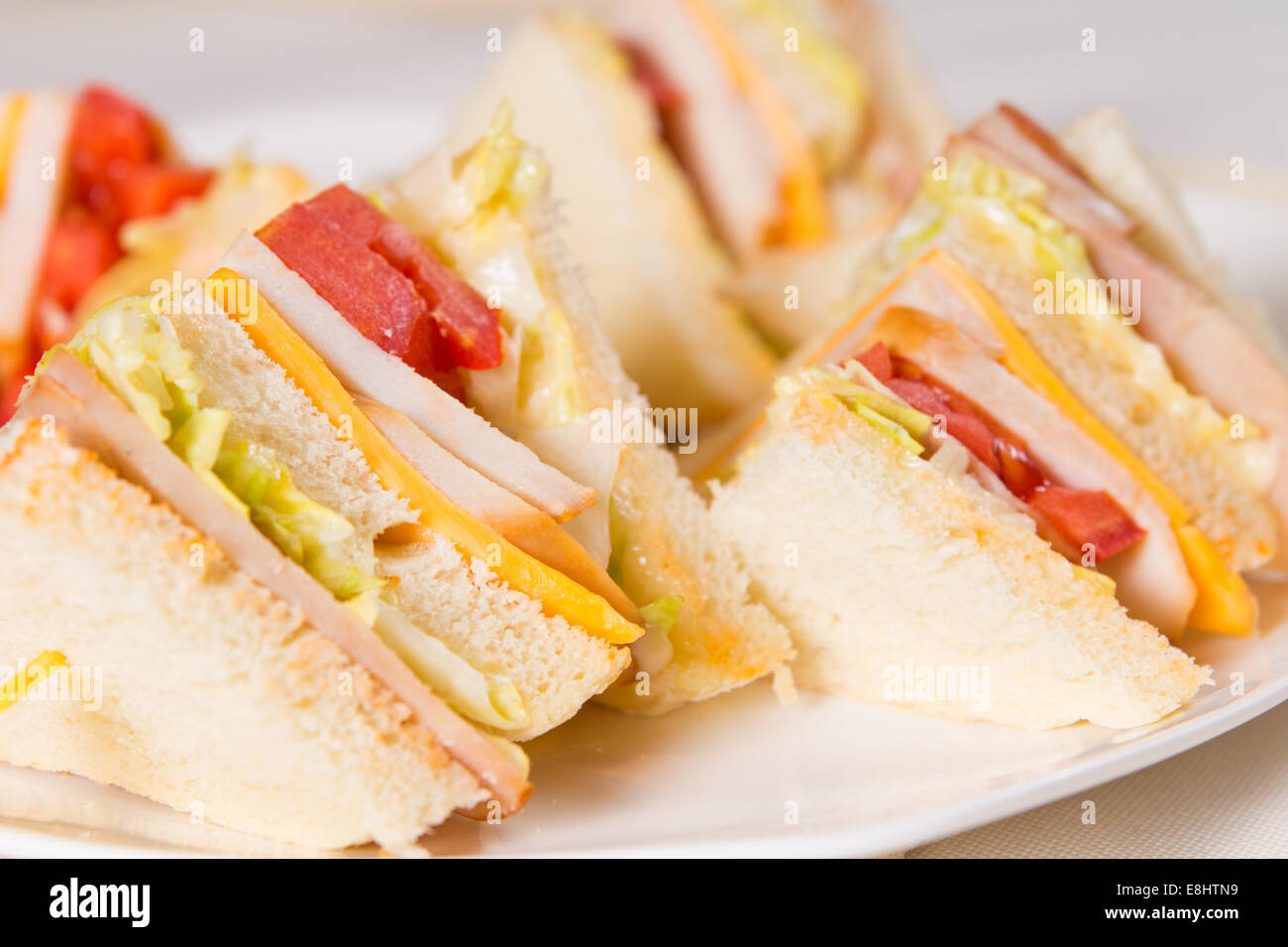 Close Up of Triple Decker Sandwich on Plate Stock Photo - Alamy