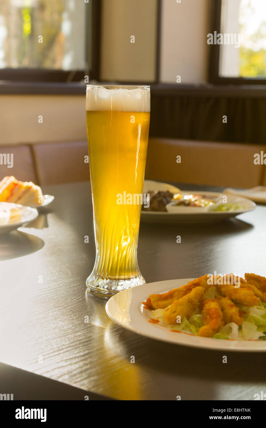 Tall Glass of Beer on Restaurant Table with Plated Food Dishes Stock ...