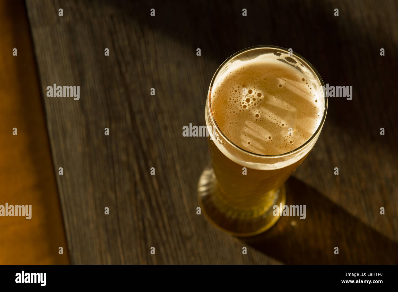 Overhead of Glass of Beer on Table in Sunlight Stock Photo - Alamy