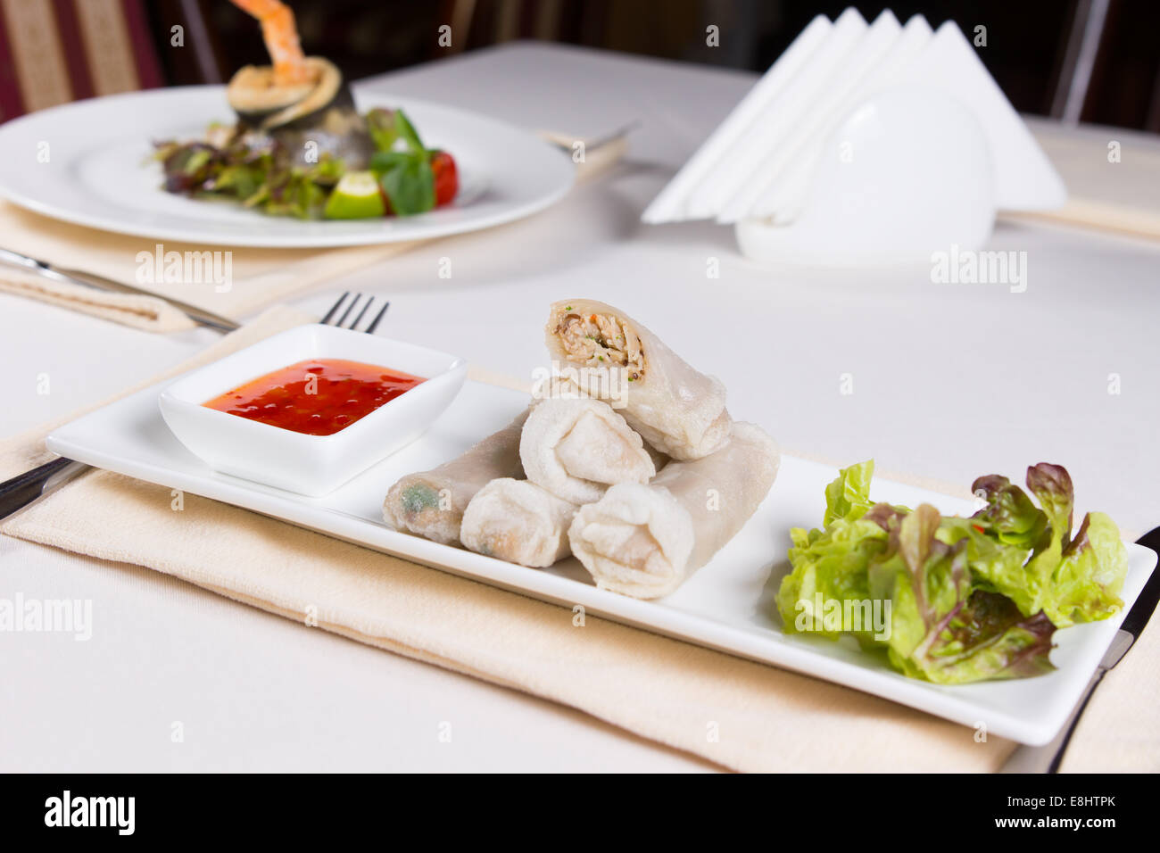 Spring Rolls Appetizer on Plate on Restaurant Table Stock Photo - Alamy
