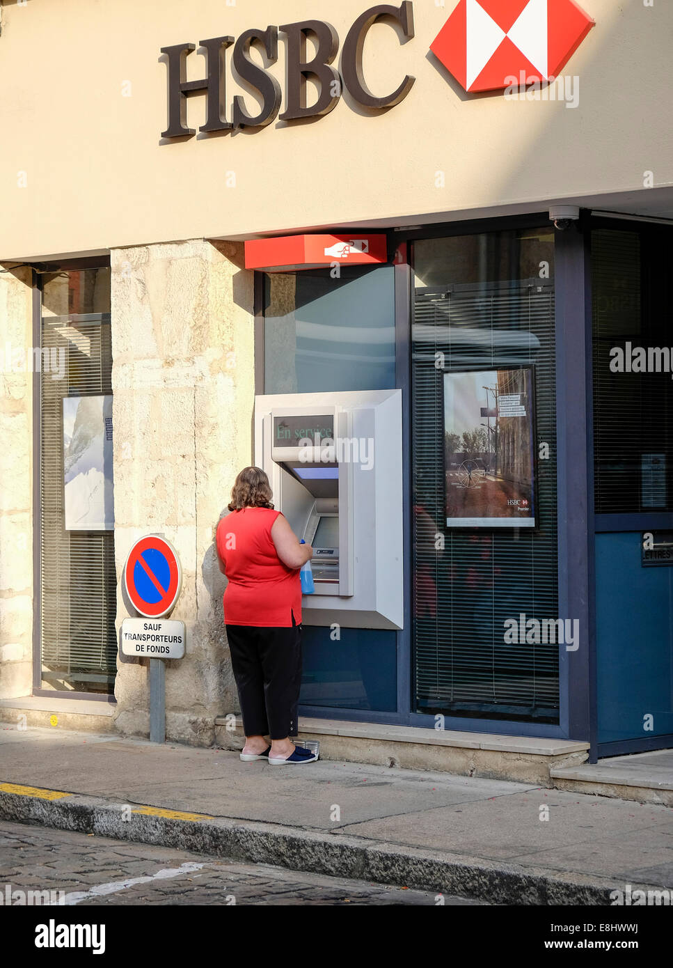 Woman using HSBC cash machine in Beaune, France Stock Photo - Alamy