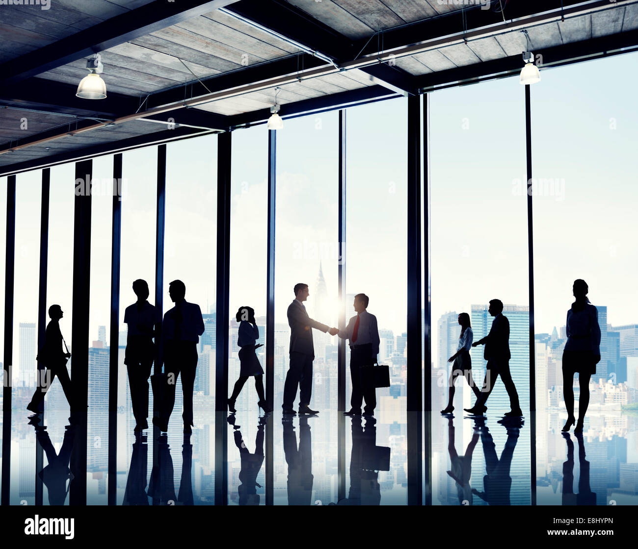 Group of business people standing in a office building Stock Photo - Alamy
