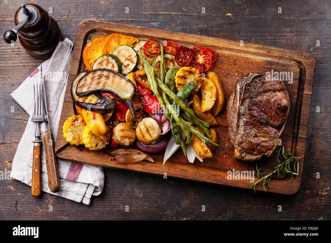Club Beef steak and Grilled vegetables on cutting board on dark wooden ...