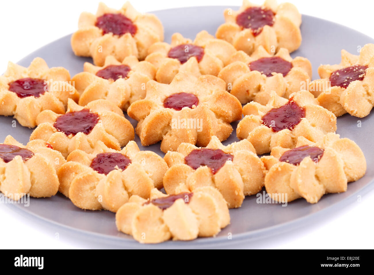 Sweet cookies with jam on gray plate isolated on white background Stock ...