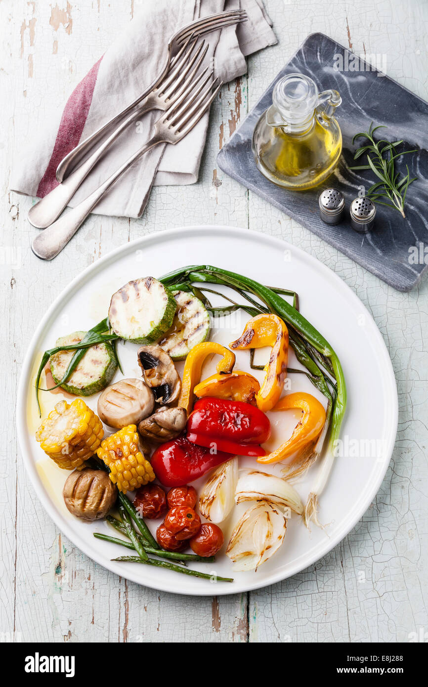 Grilled vegetables on the white plate on blue textured background Stock ...