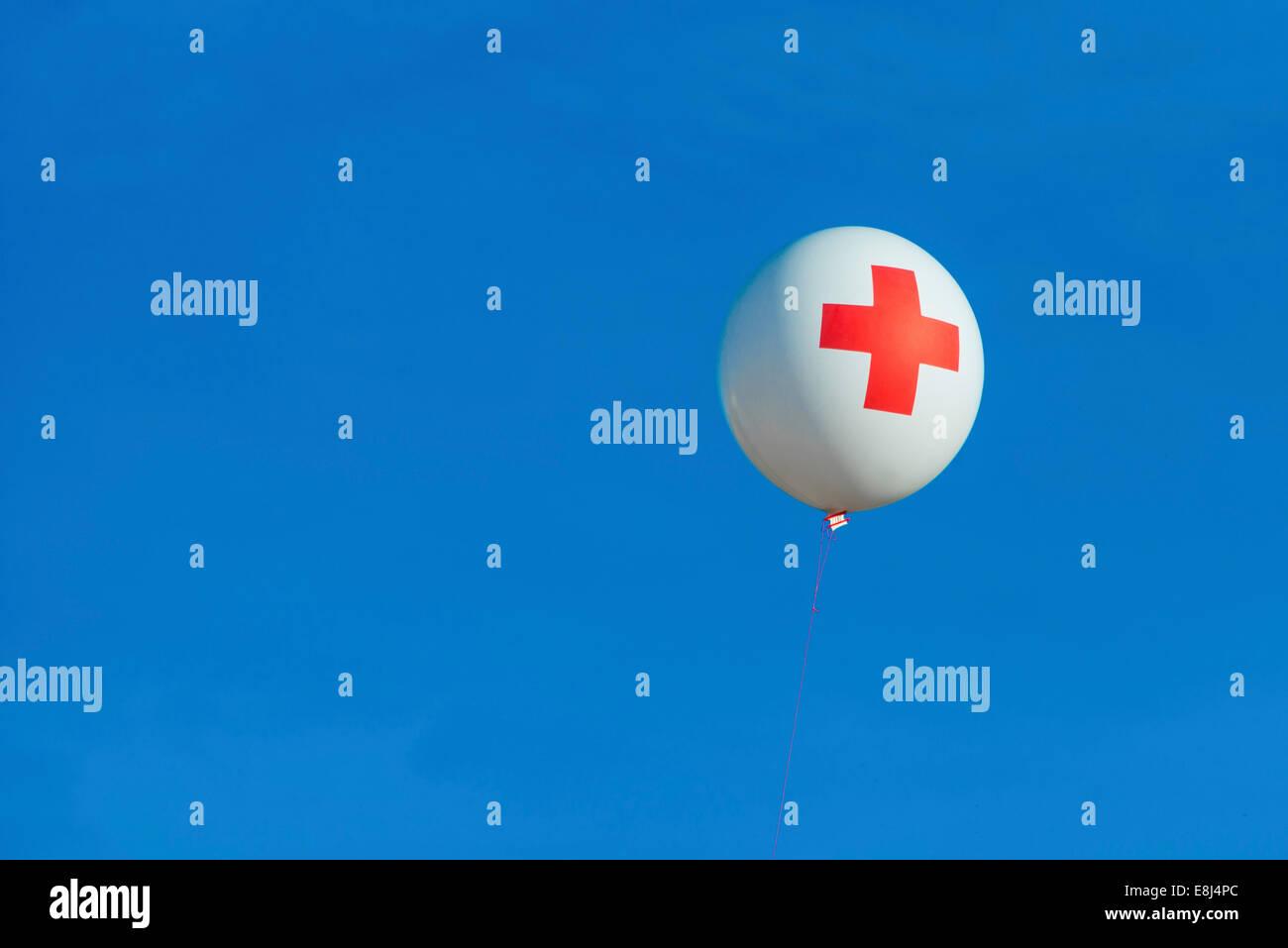 Balloon of the Red Cross in the blue sky Stock Photo - Alamy