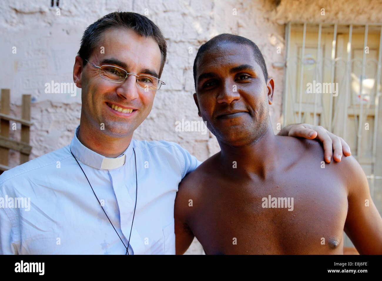 French priest Etienne Kern with a parishioner in Alagados favela Stock ...