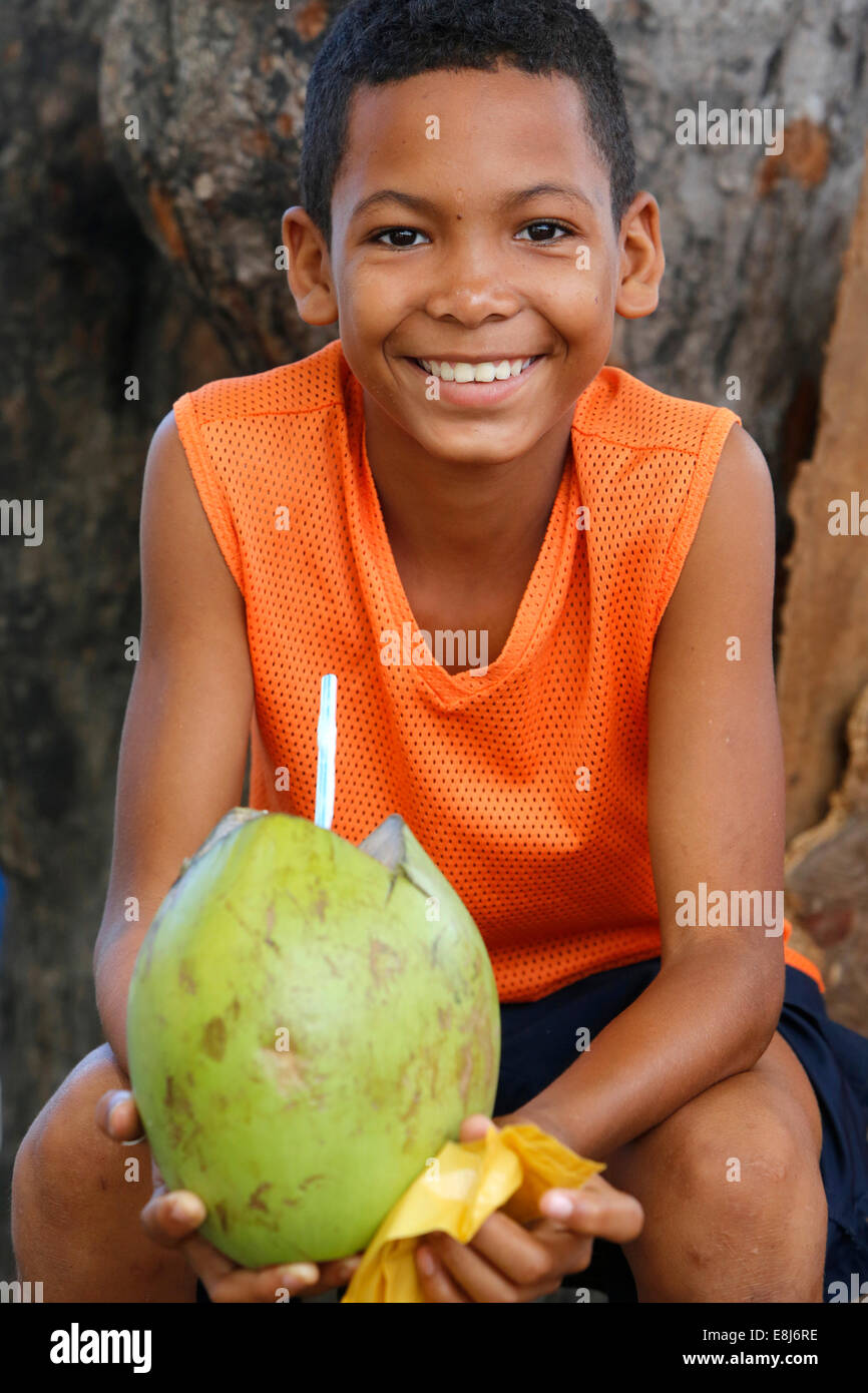 Brazilian boy holding a coconut Stock Photo - Alamy