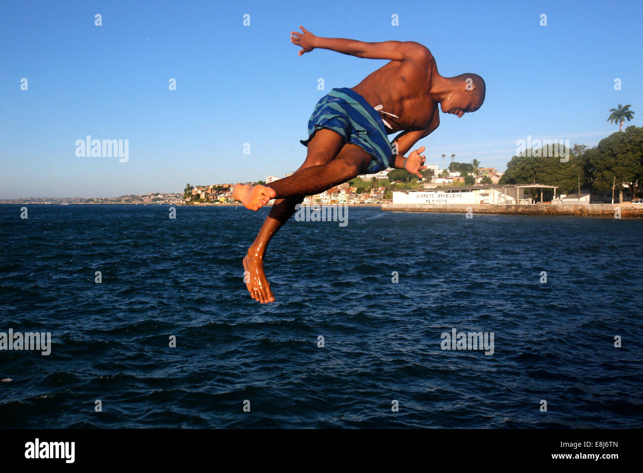Young man diving into the ocean in Salvador Stock Photo - Alamy
