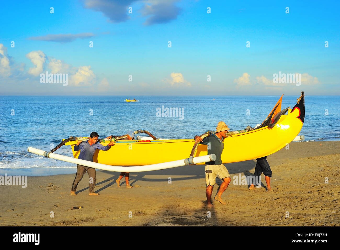 Local fishermen carrying a boat on the ocean beach Stock Photo - Alamy