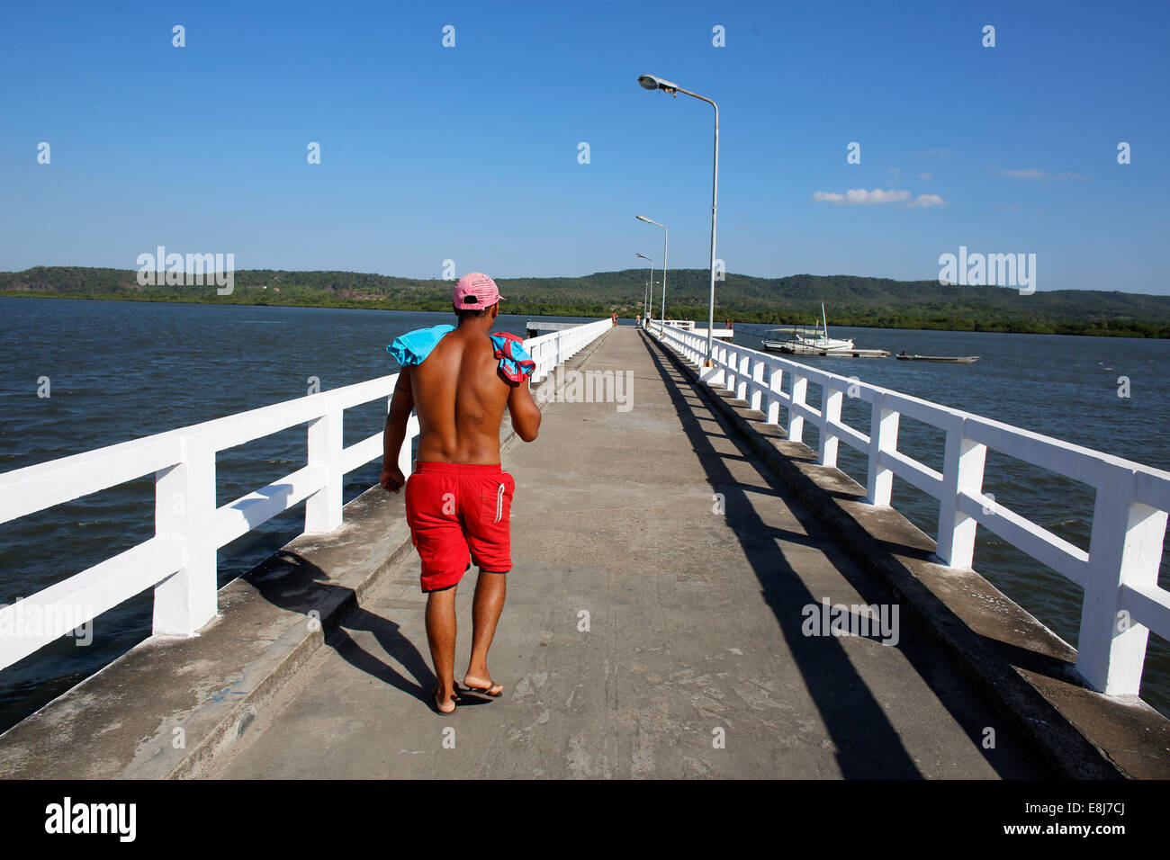 Man walking on a pier Stock Photo - Alamy