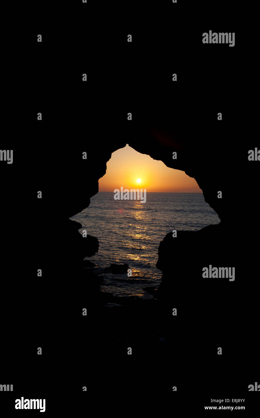 Sunset through the caves of Hercules. Cap Spartel Stock Photo - Alamy