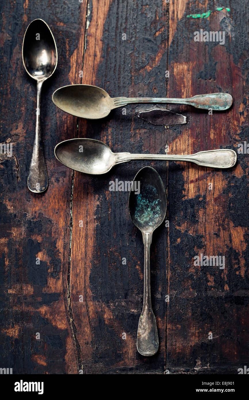 Vintage metal spoons on wooden background Stock Photo - Alamy