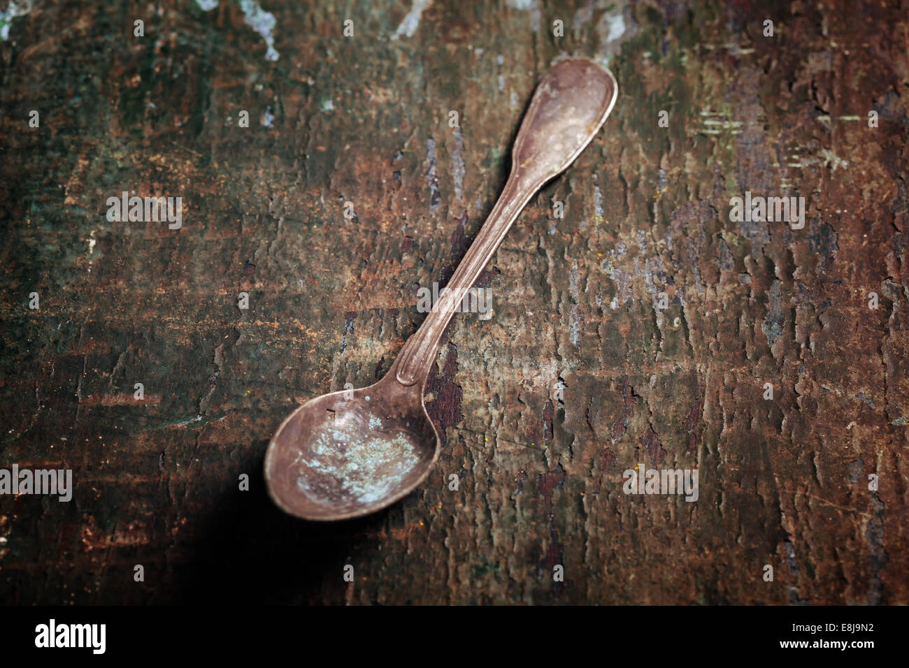 Vintage metal spoon on wooden background Stock Photo - Alamy
