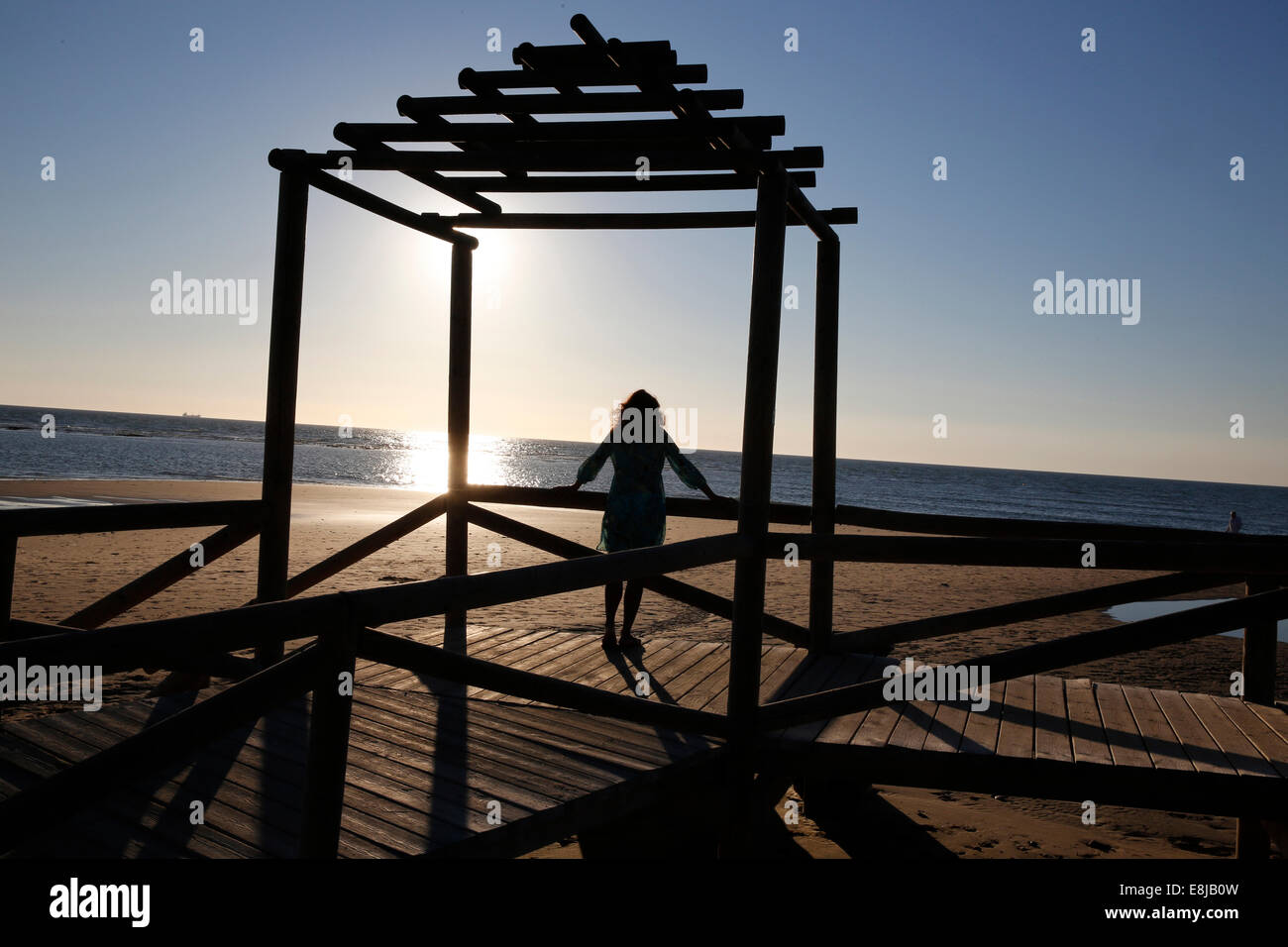 Woman contemplating the ocean Stock Photo - Alamy