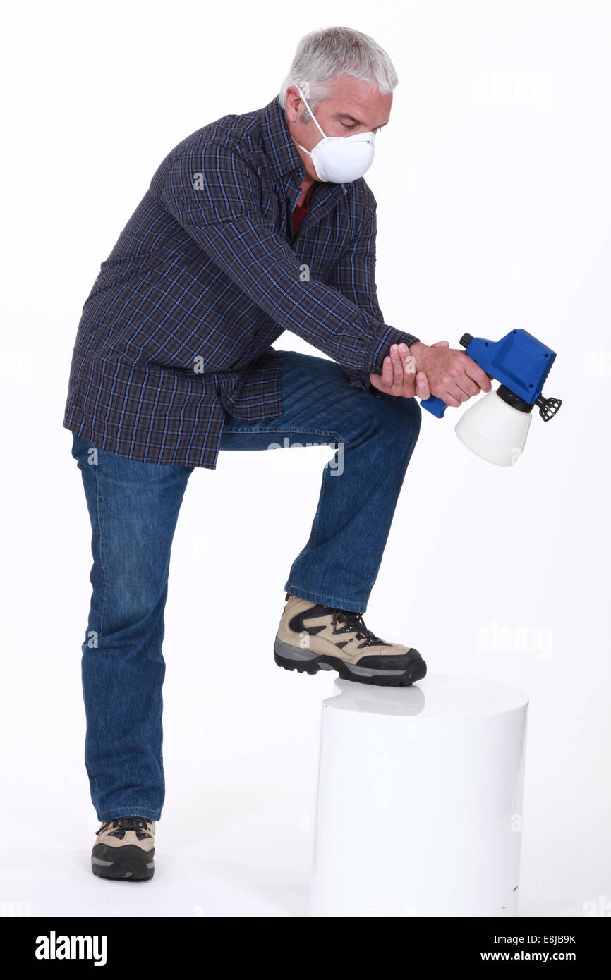 Man using a spray gun Stock Photo - Alamy