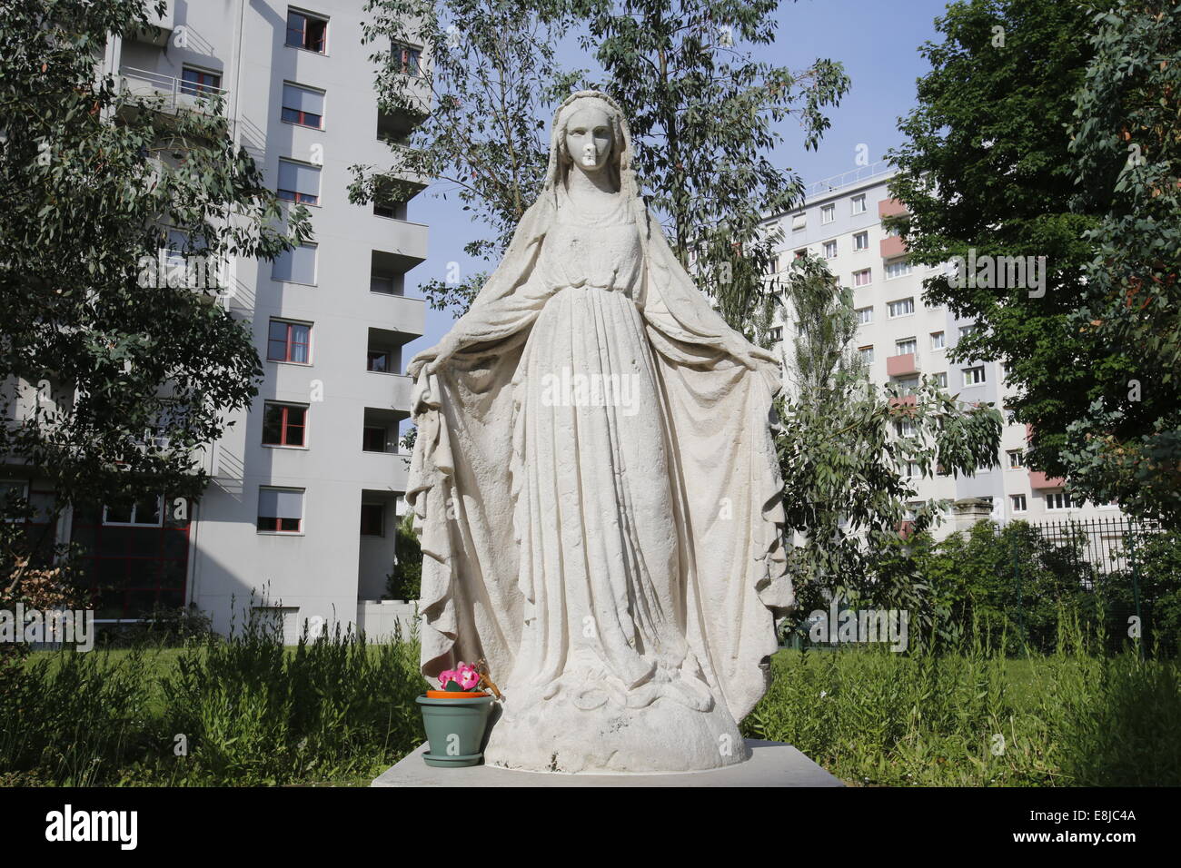 Virgin Mary sculpture and buildings Stock Photo - Alamy