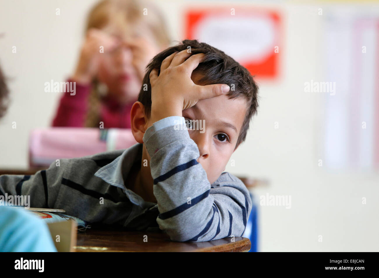 Tired child in primary school Stock Photo - Alamy