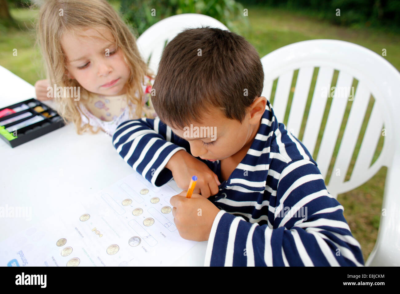 Boy and girl doing homework Stock Photo - Alamy