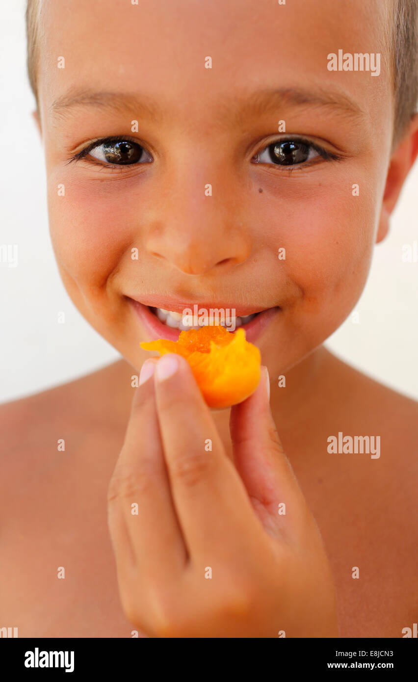 6-year-old boy eating an apricot Stock Photo - Alamy