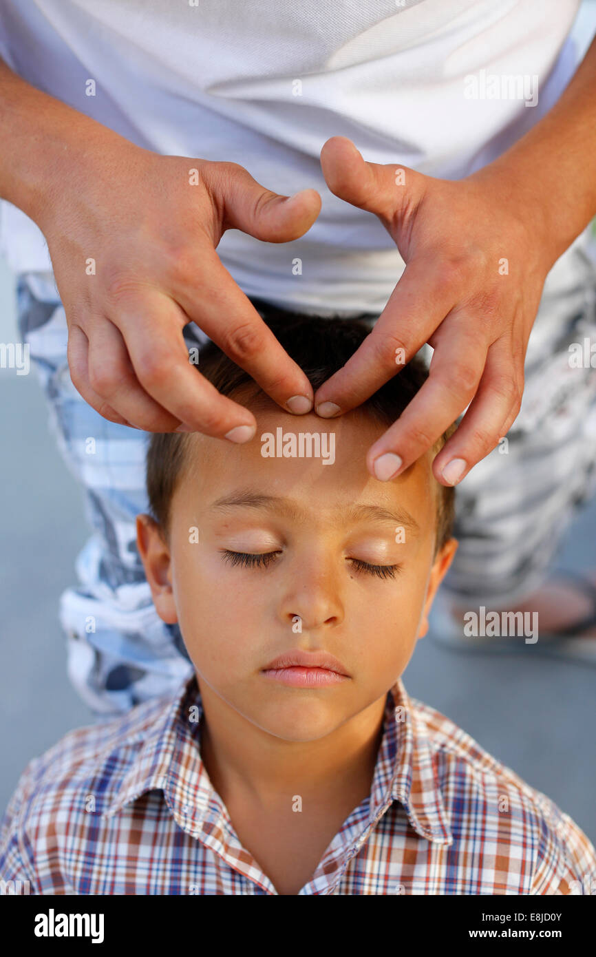 Boy receiving a head massage Stock Photo - Alamy