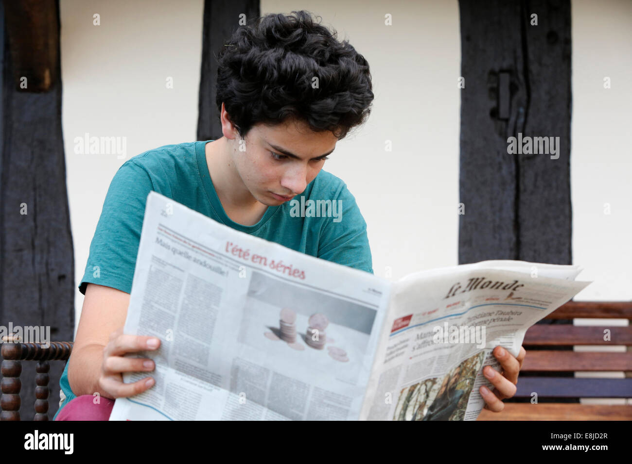 Student reading a newspaper Stock Photo - Alamy