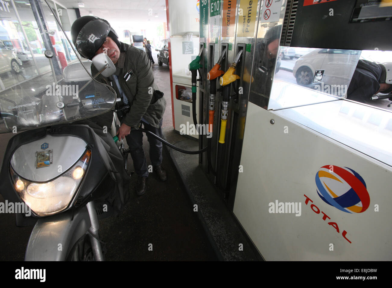 Man putting gas in his scooter Stock Photo - Alamy
