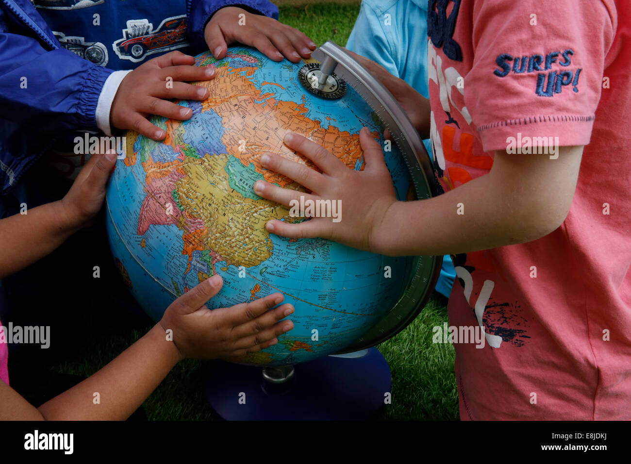 Children holding a globe Stock Photo - Alamy